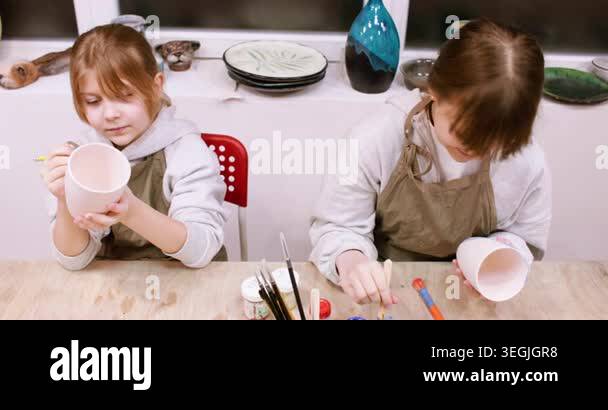 Ceramic therapy. Painting pottery. Two creative artist children drawing ...