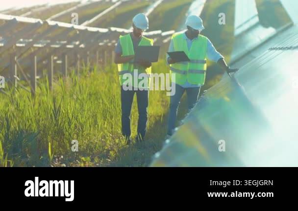 field engineers inspect solar array panels, two engineers in ...