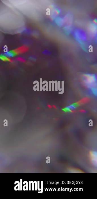 Vertical video. Defocused light prism. Reflection flash texture. Red ...