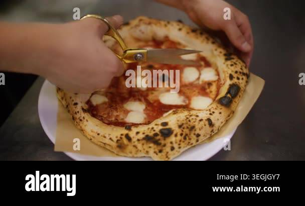 Pizza cutting slices. Pizzaiolo serving. Unrecognizable professional ...
