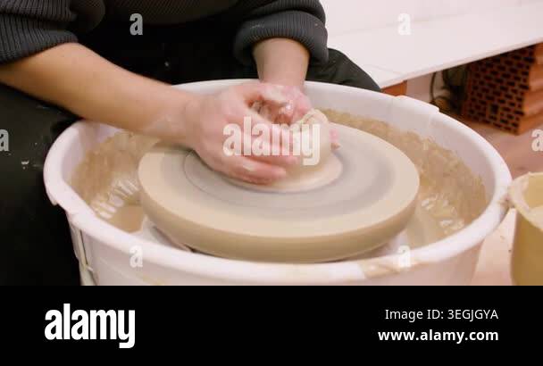 Manufacturing earthenware. Hands shaping clay. Unrecognizable ...