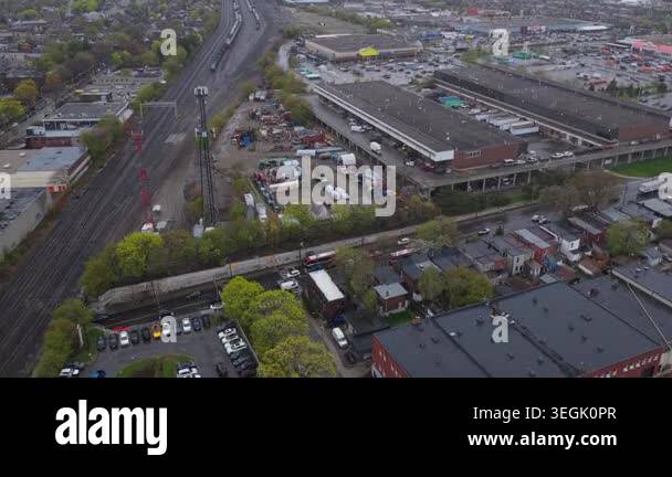 Flying over industrial area, freight train on railway, vehicles moving ...