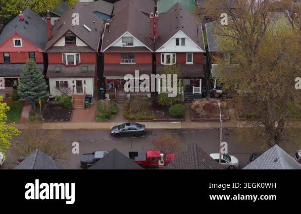 Aerial perspective of a residential street with parked vehicles and ...