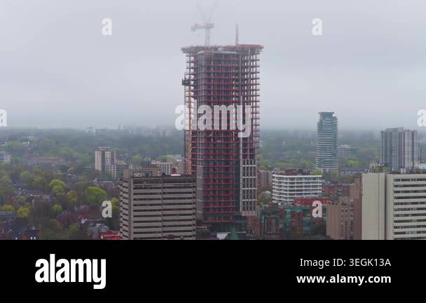 Orbiting shot revealing urban landscape with modern skyscraper under ...