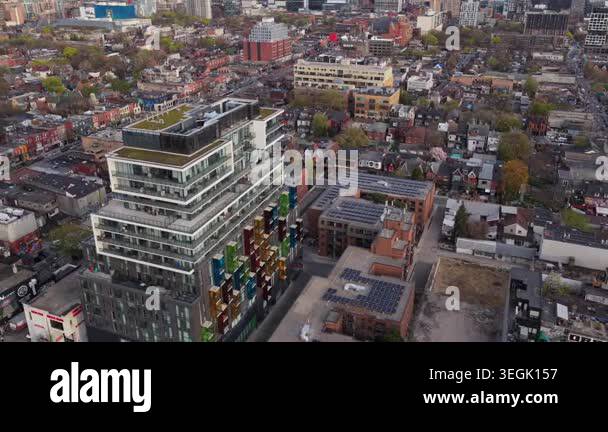Flying over modern buildings and residential district, tilting up to ...