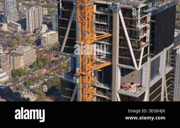 Skyscraper construction site with a tower crane, steel frame, and ...