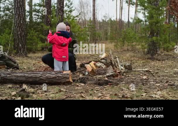 Woman and children gathering dry grass together in the forest to ...