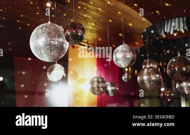 Night illumination with rotating mirror disco balls under wooden ...