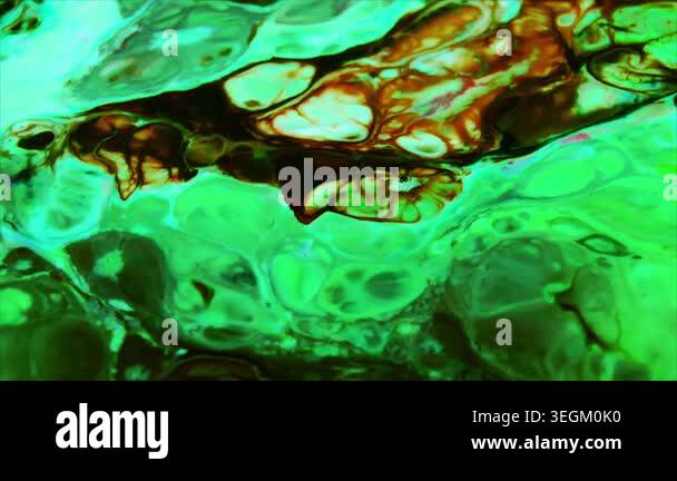 Macro view of abstract fluid art with vibrant green and brown colors ...