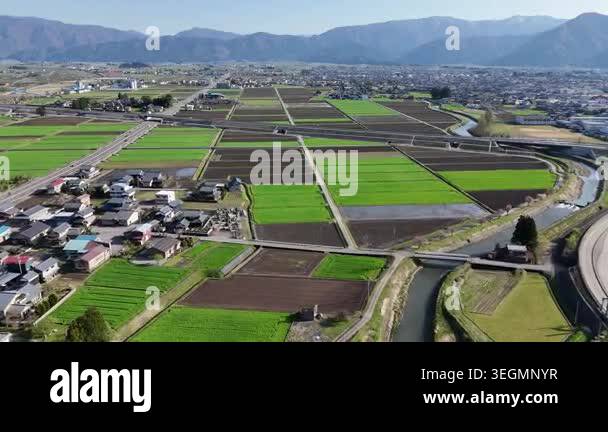 Aerial view of green fields and river Stock Video Footage - Alamy