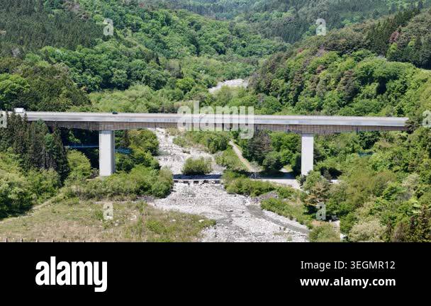 Aerial view of bridge spanning green valley Stock Video Footage - Alamy