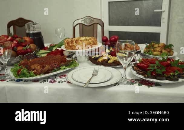 Dining table filled with an array of colorful dishes, fruits, and ...