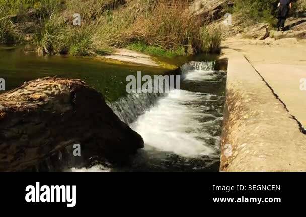 Water flowing from a natural spring emerging from the rock Stock Video ...