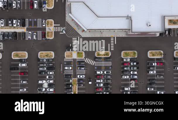 Shopping mall with extensive car parking area and dense vehicle ...