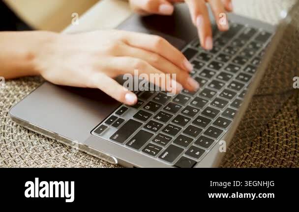 Person's hands type on a modern grey laptop keyboard with Cyrillic ...