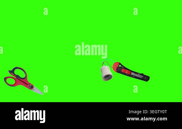 Collection of electrical and repair tools floating on a green ...
