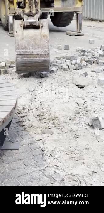 Excavator Breaking Cobblestone Street Pavement, Yellow Backhoe Bucket ...