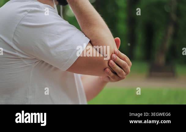 Millennial sportsman holding sore elbow joint after injury during ...