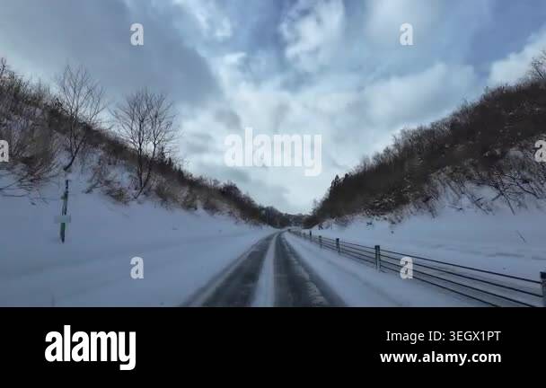 POV driving footage on a winter highway with snow-covered roadway and ...
