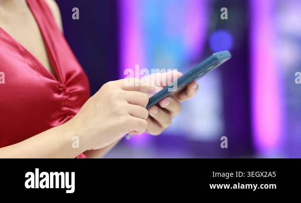 Woman in red dress using smartphone, typing and scrolling on mobile ...