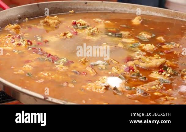 Traditional spanish paella with chicken and vegetables boiling in a ...