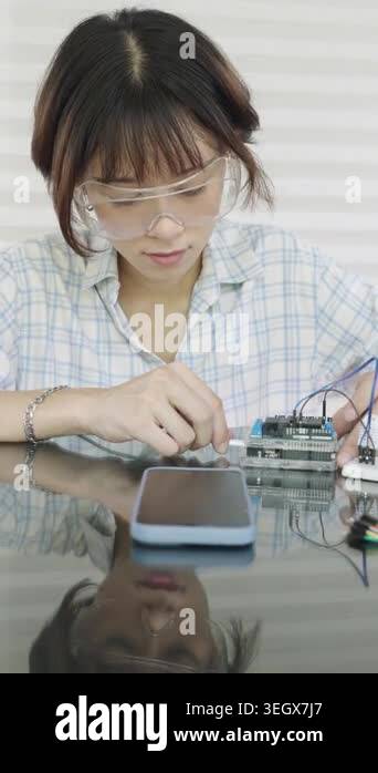 Woman is learning about and experimenting with the operation of a ...