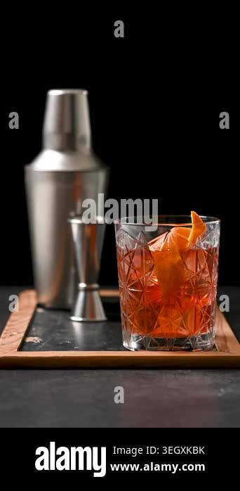 Hand Picking Up an Old Fashioned Cocktail Against Black Background ...