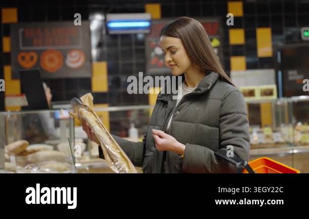 Slow motion of girl shopping in a food market while exploring shelves ...