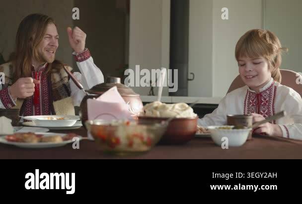 Man With Kid Boy Eat Food Lunch Dinner. Family in Ukrainian Traditional ...