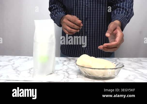 Person Showing Dough in Glass Bowl with Paper Bag on Marble Counter ...