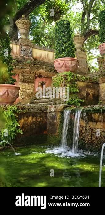 Beautiful fountain with gorgeous decorative stone vases around. Old ...