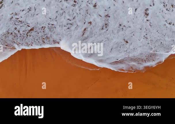 Top View of Panama Surf on Orange Sand. Top-down drone view of white ...