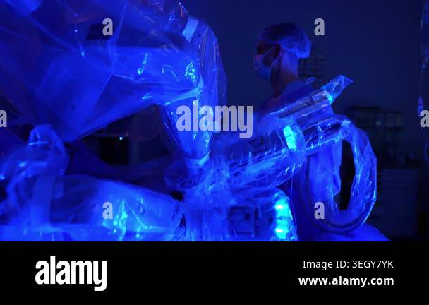 Dark room with blue light in the hospital. Medic stands behind the ...