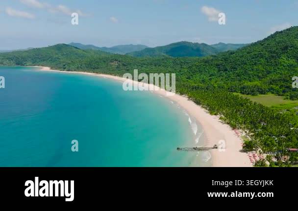 Beautiful view of ocean waves touching on sandy beach. Nacpan Beach in ...