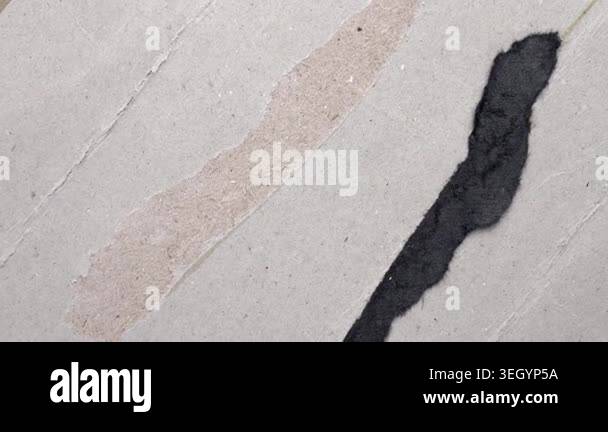 Torn grey cardboard texture with glued black paper scrap. Abstract ...