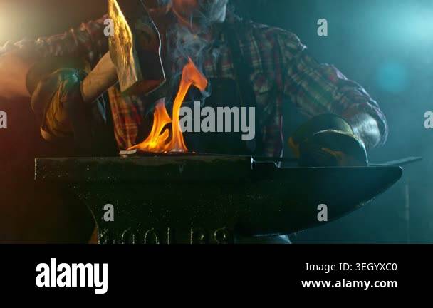 Cinematic close-up of blacksmith forging glowing hot iron on anvil with ...