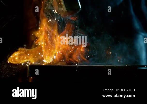 Cinematic close-up of blacksmith forging glowing hot iron on anvil with ...