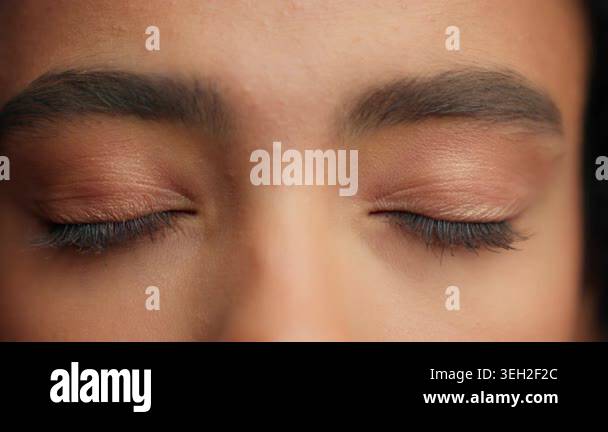 Close up female dark brown black eyes opening looking at camera ...