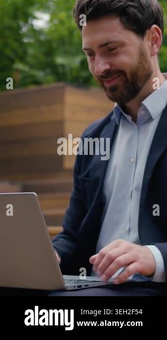 Happy Caucasian businessman celebrate good news working laptop outdoors ...