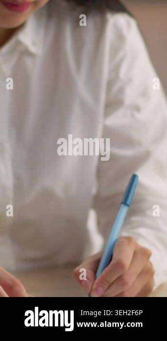Happy Asian Chinese business woman in office writing document signing ...