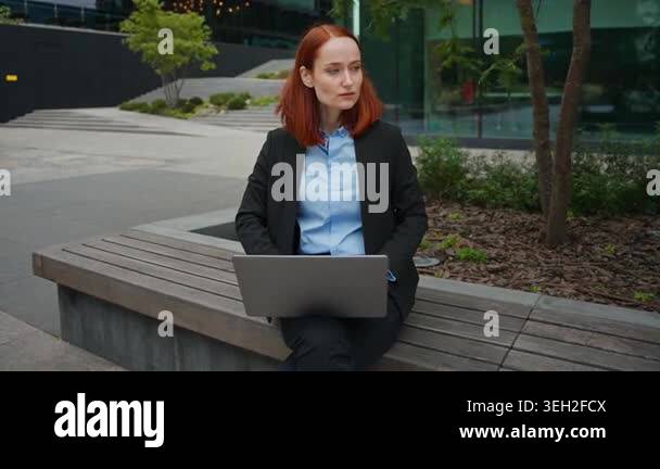 Pensive Caucasian businesswoman think solution working online laptop ...