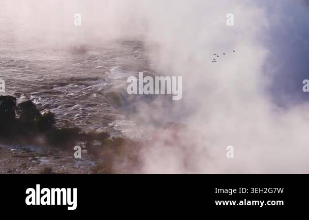 Aerial view shows Victoria Falls as water tumbles over the lip, mist ...