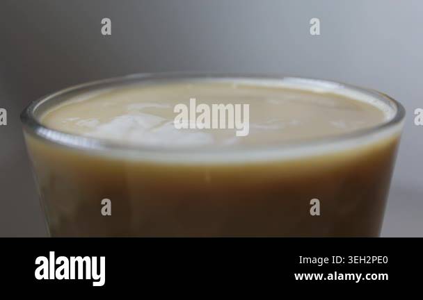 Milk drop to coffee cup and splashing up. Slow motion beverage ...