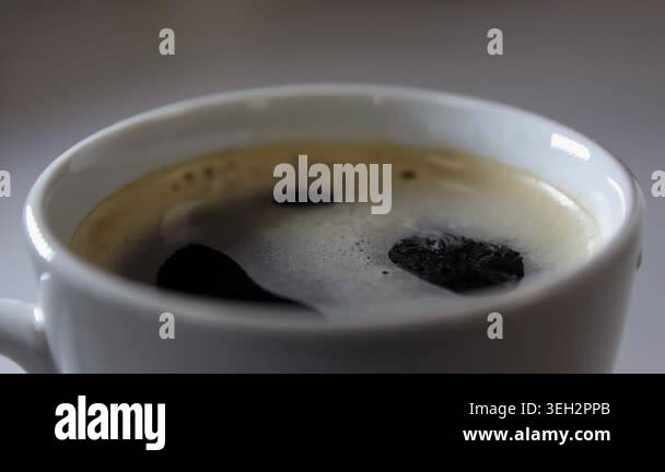 Milk drop to coffee cup and splashing up. Slow motion beverage ...