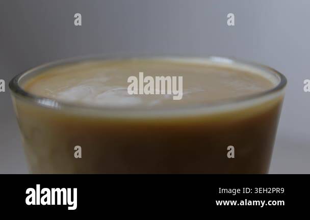 Milk drop to coffee cup and splashing up. Slow motion beverage ...