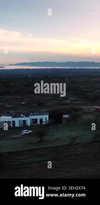 Sunset Over Remote Farmhouse Scrubland With Distant Mountains, Soft ...