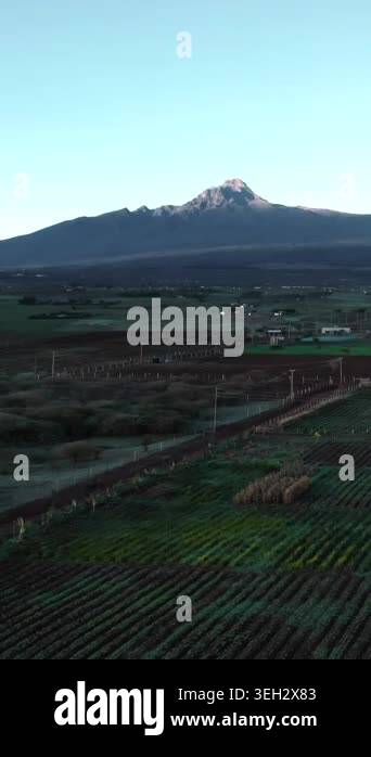 Snow Capped Mountain And Vast Fields At Dawn, Aerial Survey Capturing ...