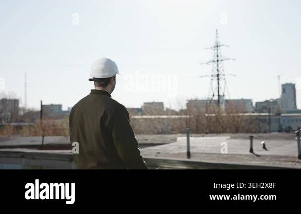 Caucasian Electrical Surveyor On Rooftop With Tablet Examining ...