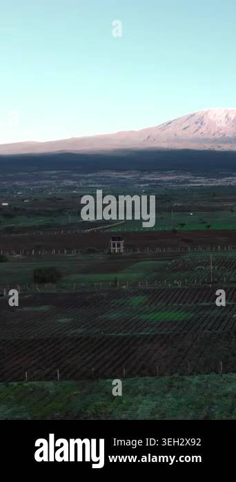 Snow Capped Mountain And Vast Fields At Dawn, Aerial Survey Capturing ...