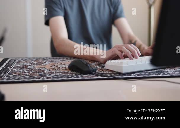 Wide shot Arms And Hands Typing On Keyboard, Patterned Mat Visible ...